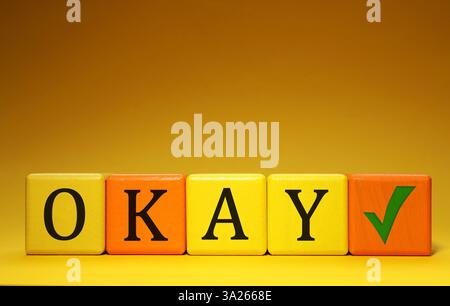 Colorful cubes with word Okay and check mark on light blue background ...