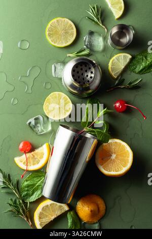 Shaker with ingredients for making cocktails. Green background. Top ...