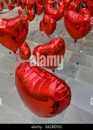 Many red heart shaped balloons on light background. Valentine's Day ...