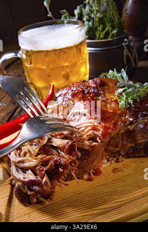 Pork with beer sauce pulled from the oven Stock Photo - Alamy