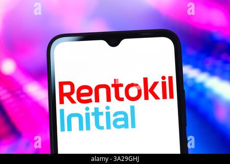 In this photo illustration, the Rentokil Initial company logo is seen ...