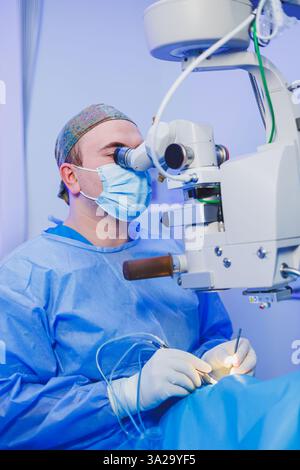 Man under a surgical microscope for vision correction. Eye surgery. A ...