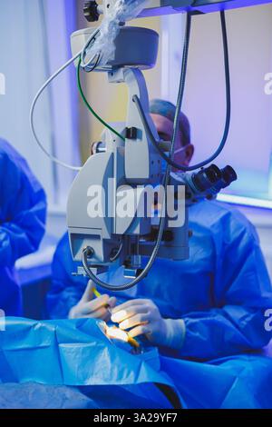 Man under a surgical microscope for vision correction. Eye surgery. A ...