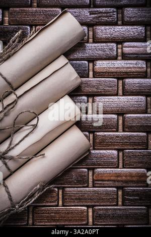 Vintage rolled document with string on wicker wooden mat Stock Photo ...