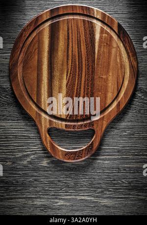 Round carving board on wood background Stock Photo - Alamy