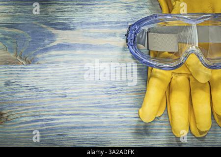 Safety spectacles leather gloves on wooden board copy space ...