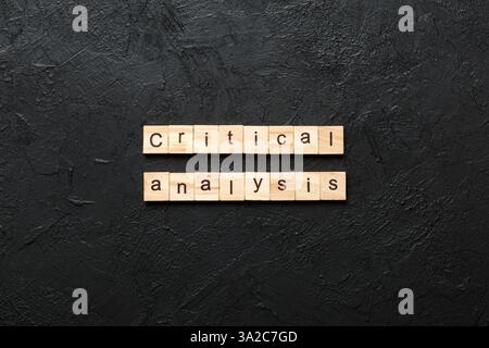 critical analysis content word written on wood block. critical analysis ...