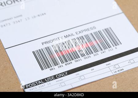 Parcel with label, closeup. Red laser light on barcode for scanning ...