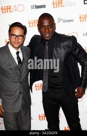 Director Cary Fukunaga and actor Idris Elba (R) attend the premiere of ...