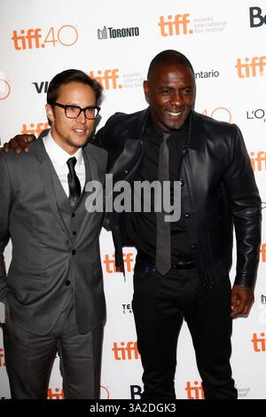 Director Cary Fukunaga and actor Idris Elba (R) attend the premiere of ...