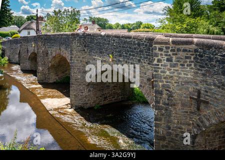 Culmstock bridge, devon with river flowing in summer sun with green ...