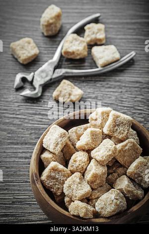Brown sugar pliers tray on striped background Stock Photo - Alamy
