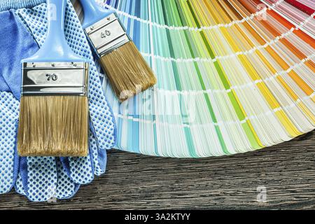 Safety gloves paint brushes color sampler on wooden board Stock Photo ...