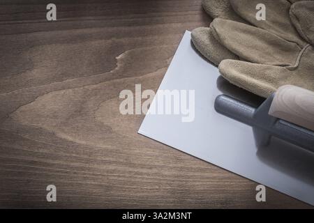 Safety gloves and glazed plastering trowel top view construction ...