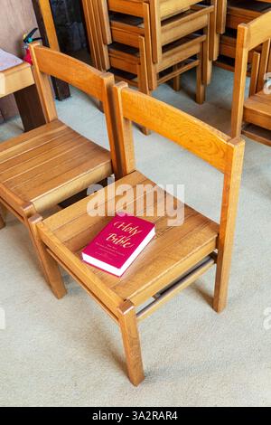 The Holy bible on a chair Stock Photo - Alamy