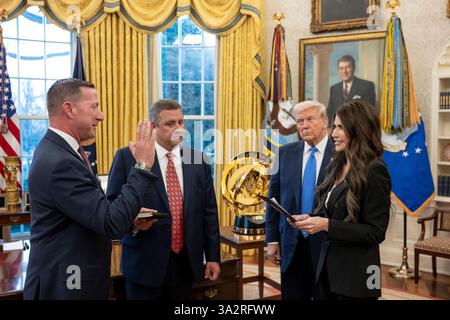 Homeland Security Secretary Kristi Noem looks at rifles in the armory ...
