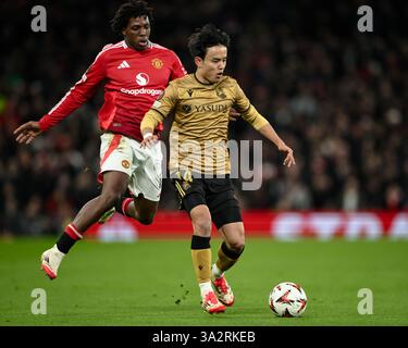 Patrick Dorgu of Manchester United breaks with the ball tracked by Enzo ...