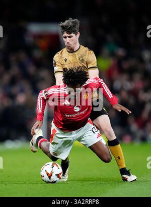 Manchester United's Patrick Dorgu, left, fights for the ball with ASEAN ...