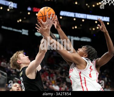 Houston guard Mercy Miller (25) drives around Rider guard Antwan Wilson ...