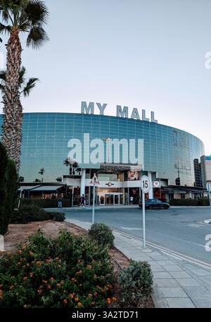 Evening view of Limassol cityscape with palm trees and waterfront ...