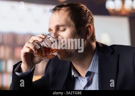 Upper class billionaire drinking whiskey at the elite social club ...