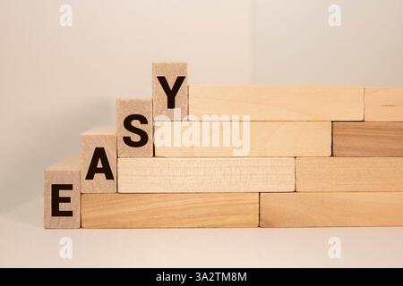 We make it easy symbol. Concept words We make it easy on wooden cubes ...