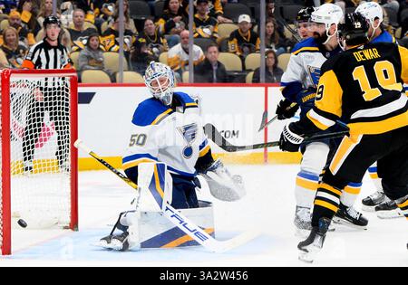 Pittsburgh Penguins center Connor Dewar, left, reaches for the puck as ...