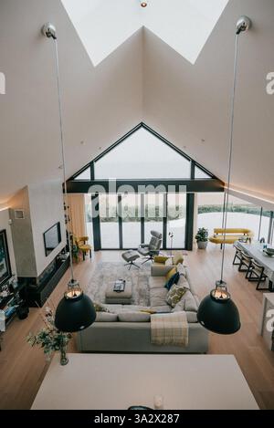 Large, empty room with a tan wall and a tan carpet. The room has a ...