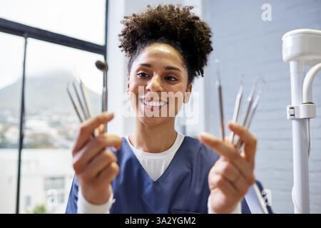 Female dentist with dental tools on blue background. World Dentist Day ...