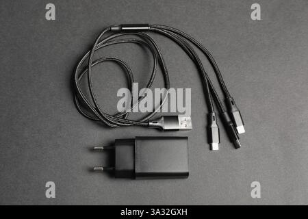 USB power adapter and triple charge cable isolated on white Stock Photo ...