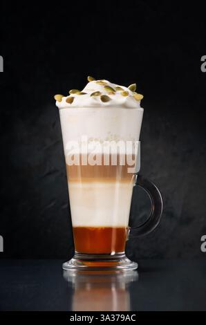 Pumpkin spice latte concept. Decorative pumpkin and cones next to hot ...