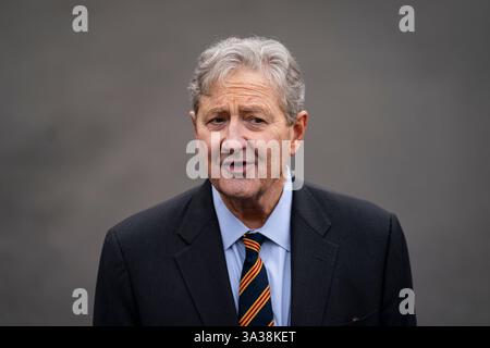 Sen. John Kennedy (R-La.) speaks with an aide as he departs a Senate ...