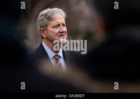 Sen. John Kennedy (R-La.) speaks with an aide as he departs a Senate ...