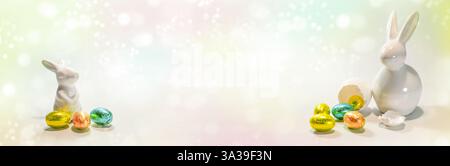 Two Easter Bunnies. Easter background with colored Easter eggs and ...