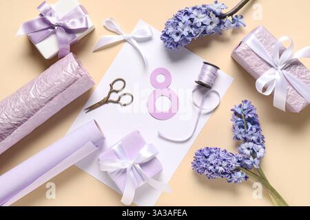 Figure 8 with lilac flowers, gift boxes and wrapping paper on beige ...
