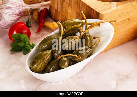 Marinated Caper Berries snack appetiser in the bowl Stock Photo - Alamy