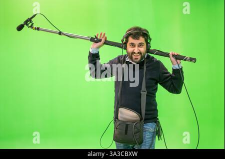 Boom microphone operator testing sound at TV studio. High quality ...