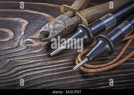 Vintage electric tester pliers on wooden board electricity concept ...