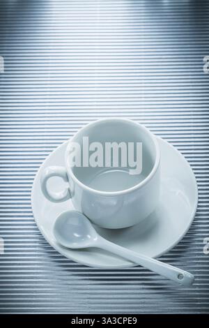 Ceramic cup saucer teaspoon on striped background Stock Photo - Alamy