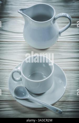 Ceramic cup saucer teaspoon creamer on wooden board Stock Photo - Alamy