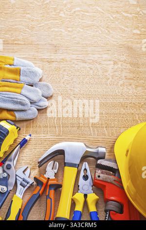 Nippers safety gloves hard hat tape measure on wooden board Stock Photo ...