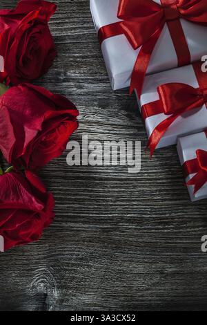 White gift box bunch of scented red roses on wooden board Stock Photo ...