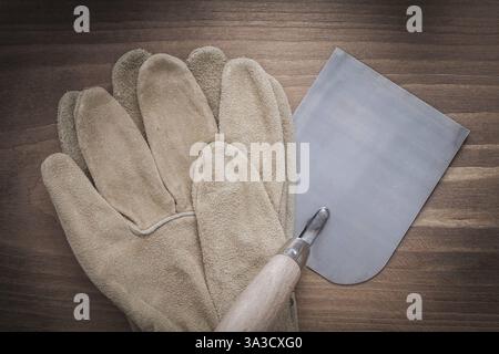 Bricklaying trowel working gloves on concrete background construction ...