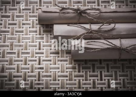 Vintage rolls of paper on wicker wooden background Stock Photo - Alamy