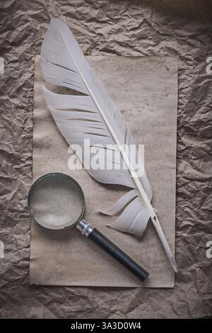 Rolled aged paper feather on wood board top view Stock Photo - Alamy