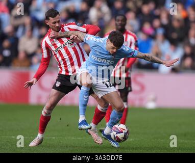 Sunderland's Eliezer Mayenda and Coventry City's Liam Kitching (right ...