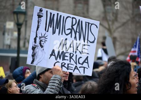 A demonstrator protests against federal immigration sweeps during a ...