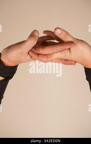 Against a neutral background, the gesture acts as a universal emblem of ...