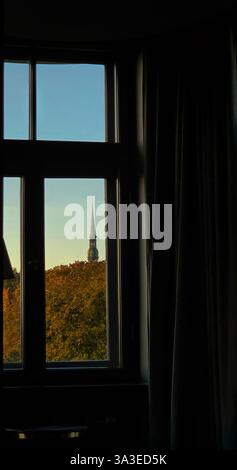 View from a dark stone window reveals a distant ancient fortress ...