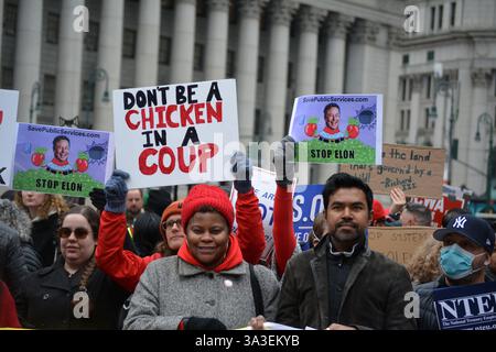 People marching with signs at a Stop the Cuts rally against DOGE in ...